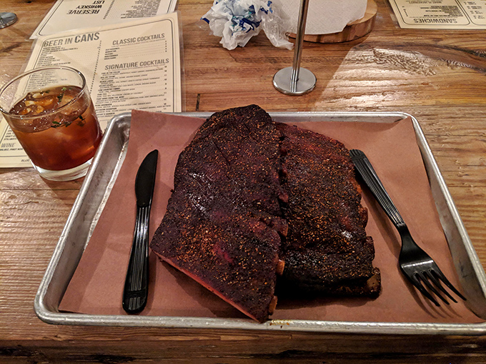 These ribs don't just have a smoke ring—they have a smoke halo. The kind of bark that makes you want to write poetry about meat.