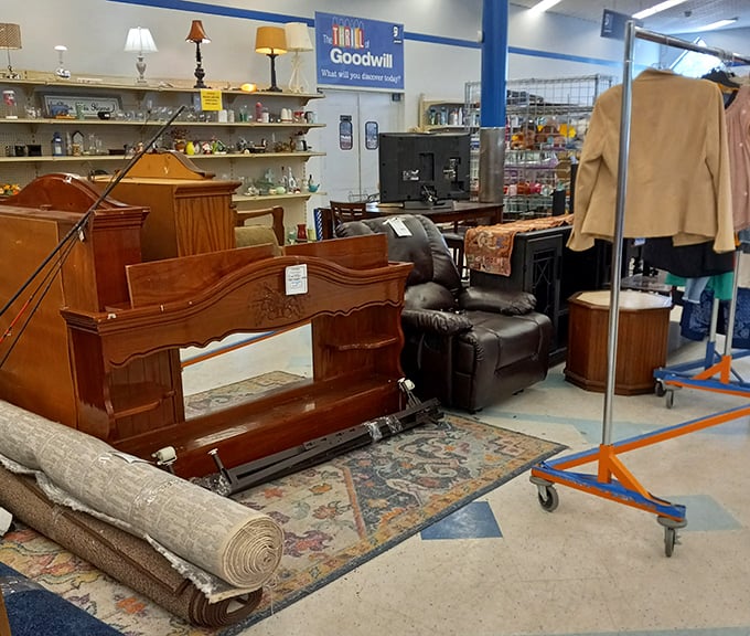 Furniture vignettes create little living rooms throughout the store. That carved wooden headboard probably has stories to tell.