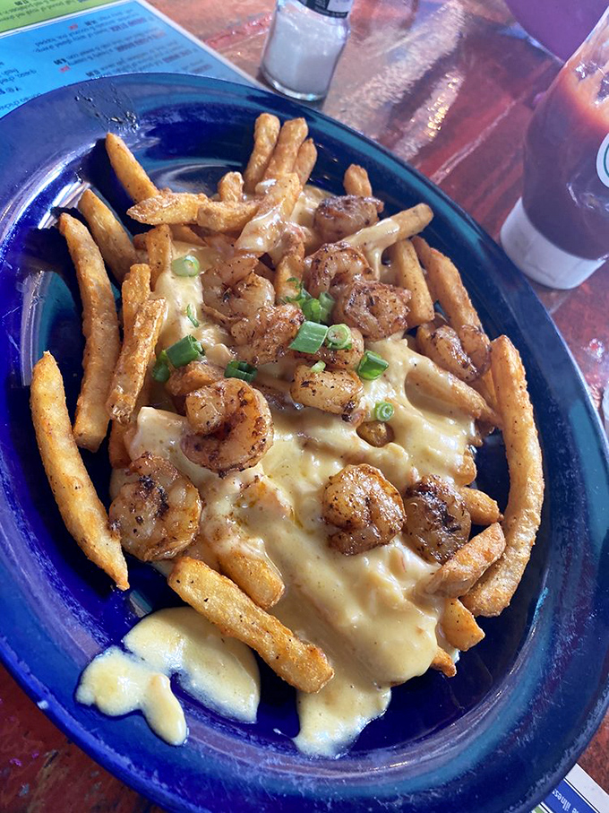 Crispy fries swimming in creamy sauce and topped with blackened shrimp&mdash;proof that sometimes the best seafood doesn't need the ocean.