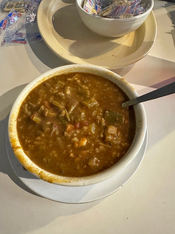 A bowl of gumbo that looks like it contains the collective wisdom of several generations. Spoons were invented for moments like this.