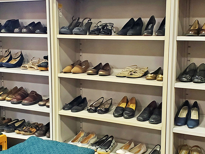Shoes, shoes everywhere, but which pair to take? Each shelf offers footwear with previous lives and future adventures.