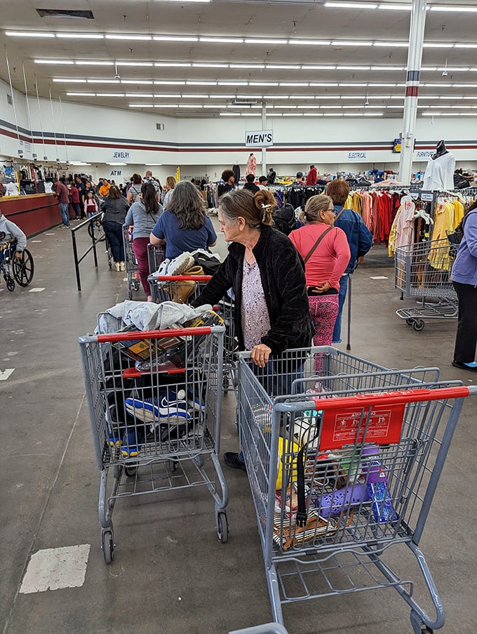 Serious shoppers navigate carts with strategic precision&mdash;these aren't amateurs but professional treasure hunters on the scent of their next great find.