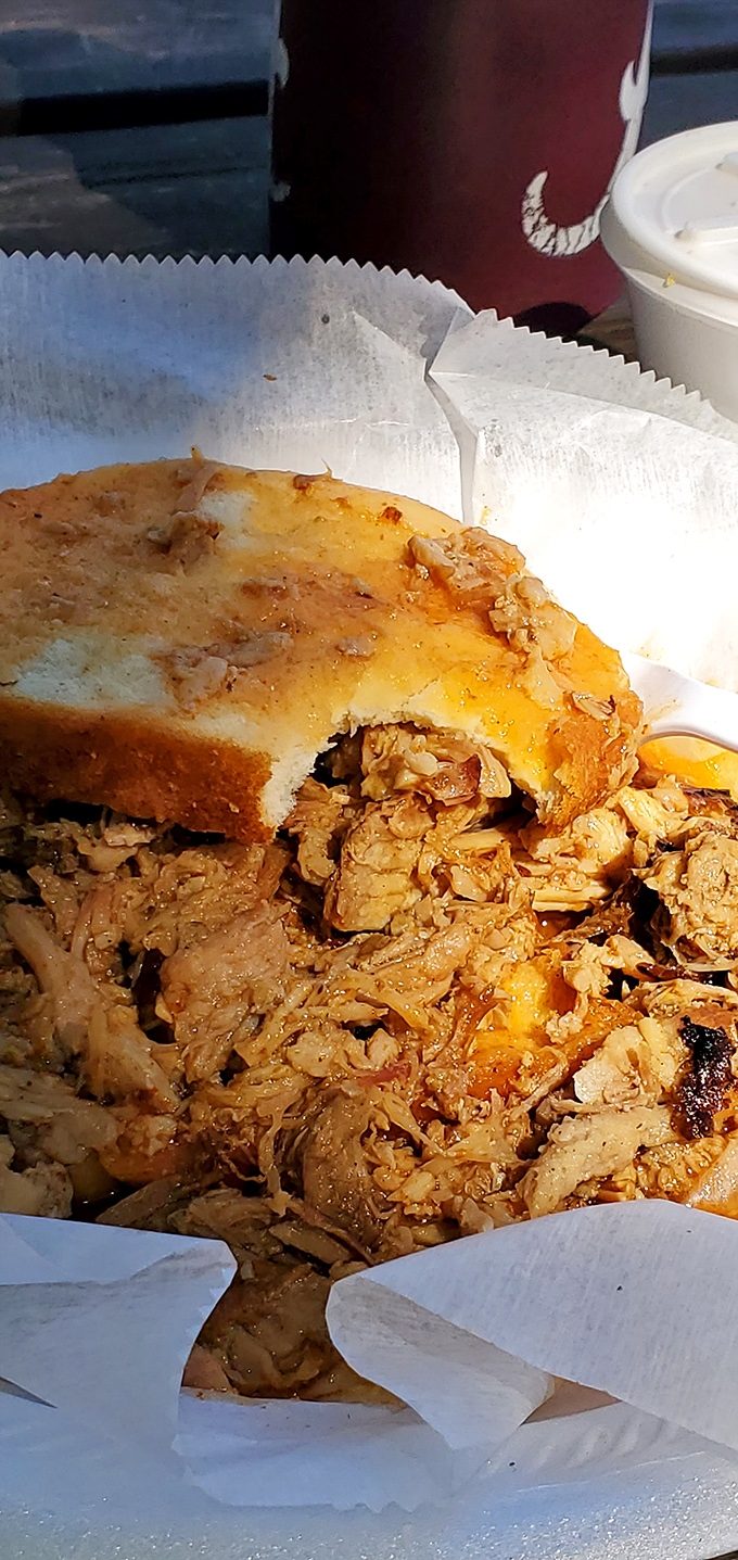 Pulled pork so tender it practically surrendered to the smoker. Paired with white bread that's the perfect canvas for that signature orange-red sauce.