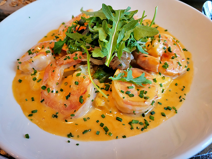 Gulf shrimp swimming in creamy grits with a splash of color from fresh arugula&mdash;Southern comfort that traveled north and found its perfect home.