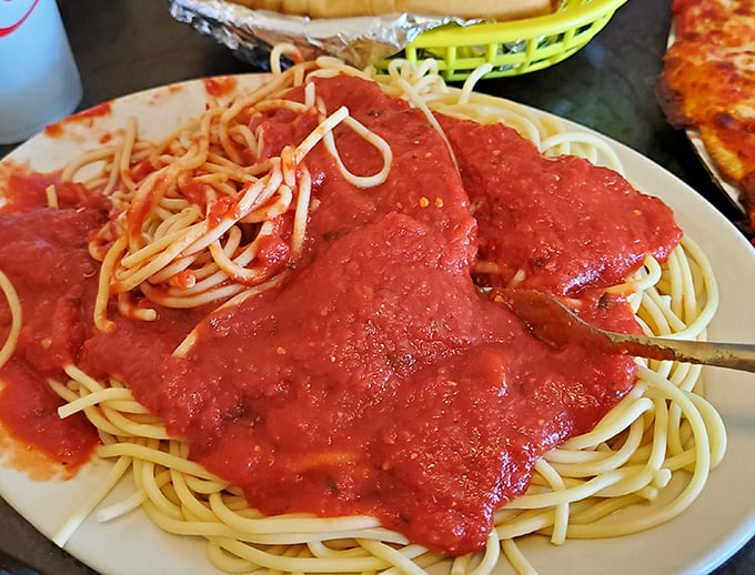 Spaghetti swimming in vibrant homemade sauce that would make Italian grandmothers nod in silent, begrudging approval.