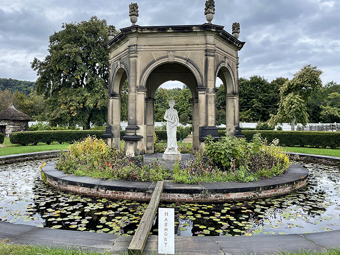 Harmonia's statue stands serene amid lily pads and formal gardens, a limestone reminder of ideals that shaped this corner of Pennsylvania.