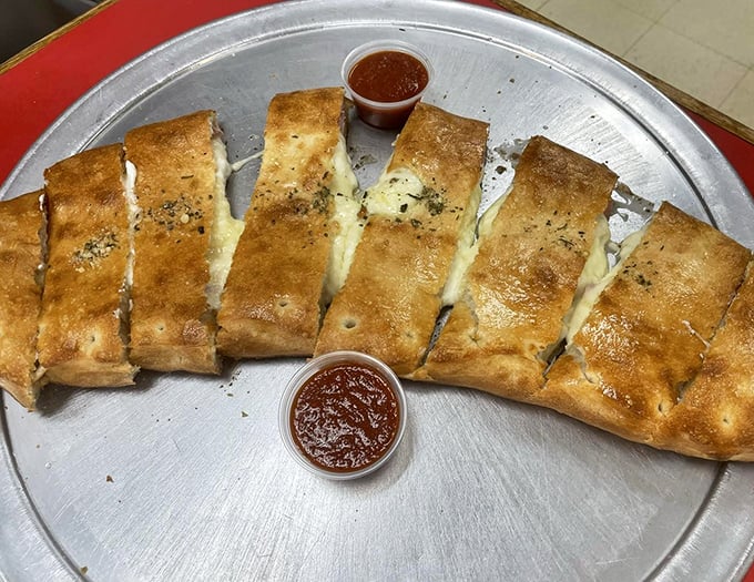 The stromboli, sliced and ready for battle. That golden-brown exterior is just the opening act to the gooey, meaty symphony waiting inside.