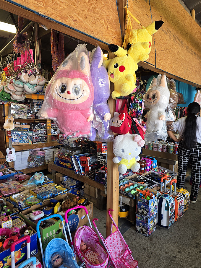 Plush paradise! Giant stuffed characters dangle from the rafters while toy-filled tables below create a nostalgic playground for all ages.