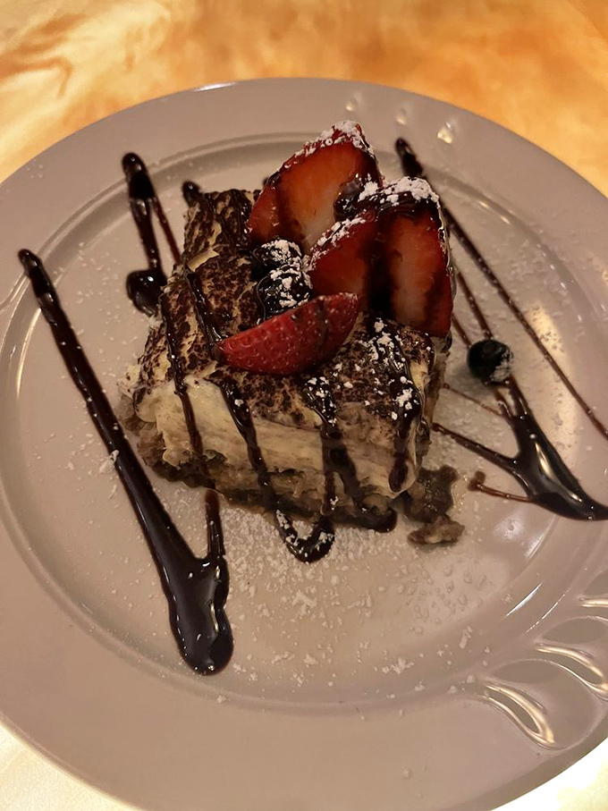 This isn't just tiramisu; it's a cloud of mascarpone heaven dotted with strawberries and chocolate that whispers, "Diet tomorrow."