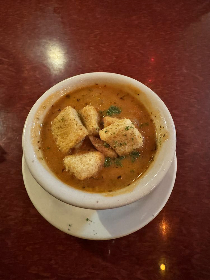 A bowl of tomato soup that makes you question why you ever settled for the stuff from a can. Those croutons aren't just floating&mdash;they're making a statement. 