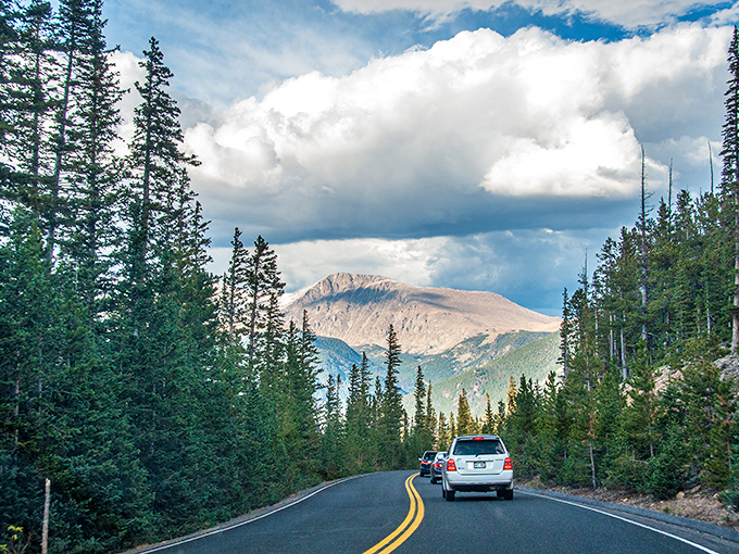 The highway threads through rocky sentinels, a testament to engineering ambition meeting nature's most imposing obstacles.