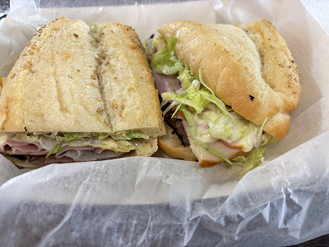 A sandwich so perfectly constructed it could teach architecture classes at Auburn—layers of meat, cheese, and veggies in harmonious balance.