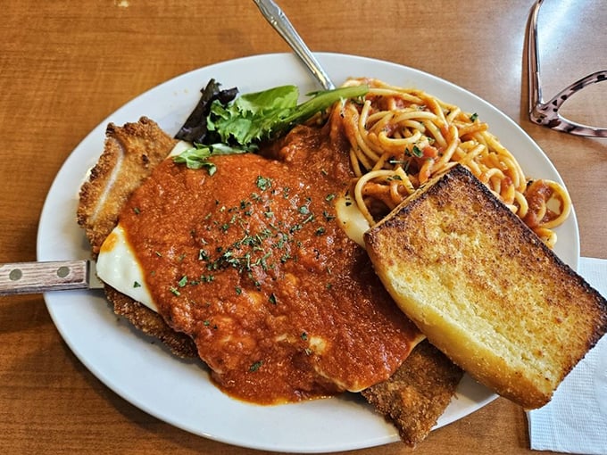 Veal parmesan that would make any Italian grandmother nod in approval—crispy, saucy, and served with enough garlic bread to scare vampires away.