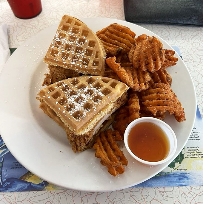 Whoever decided to sandwich crispy fried chicken between waffles deserves a Nobel Prize in comfort food engineering. The honey drizzle is just showing off.
