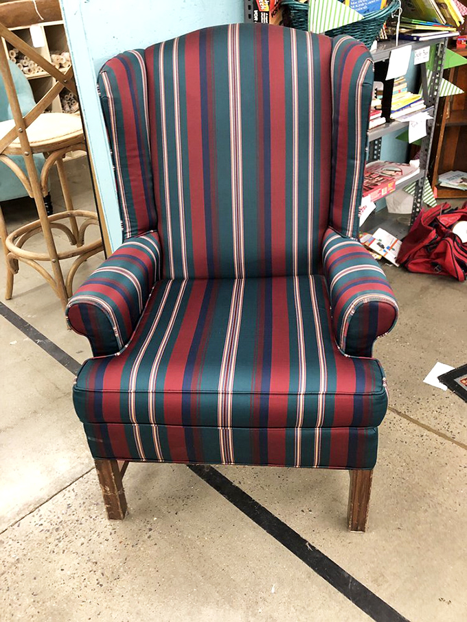 This wingback chair has seen some stories. With stripes bold enough for a 1980s power suit, it's waiting for its next chapter.