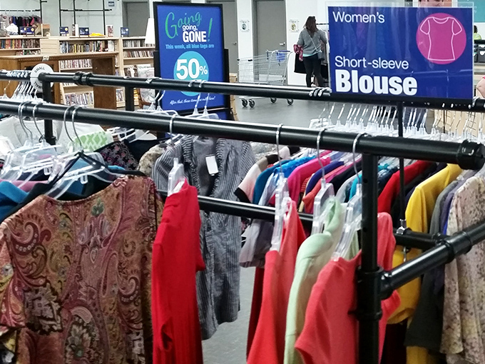 The women's blouse section: where "Going, Gone!" signs remind you that hesitation is the enemy of thrift store victory.