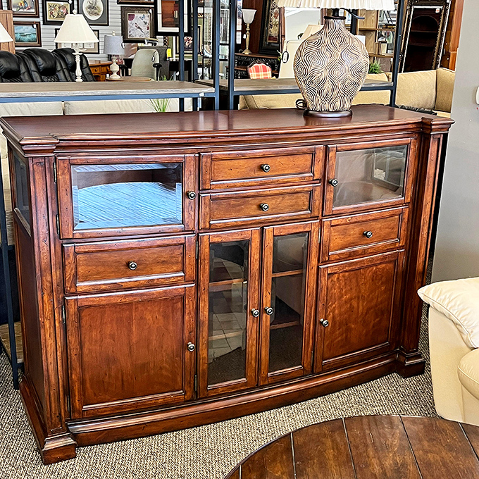 This isn't just a sideboard; it's a time machine crafted from rich wood that whispers tales of dinner parties past and future family gatherings.