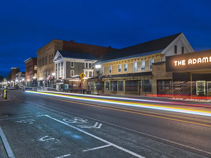 Light trails paint Adams after dark, where historic buildings house apartments costing less than your cousin's car payment in Boston.