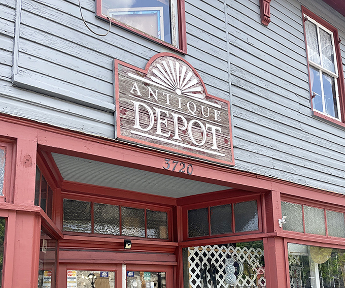 The weathered sign above Antique Depot tells stories before you even step inside this charming blue-green time capsule.