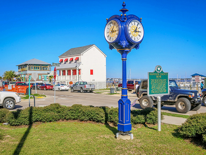 Bay St. Louis' blue clock stands proud as a peacock, marking time while boats and bridges create the perfect coastal composition behind it.