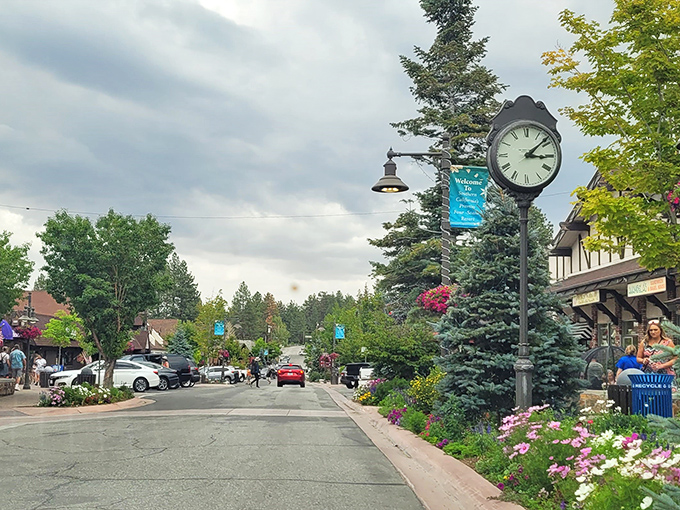 That classic mountain town clock keeps perfect time while colorful flowers bloom along tree-lined streets below.