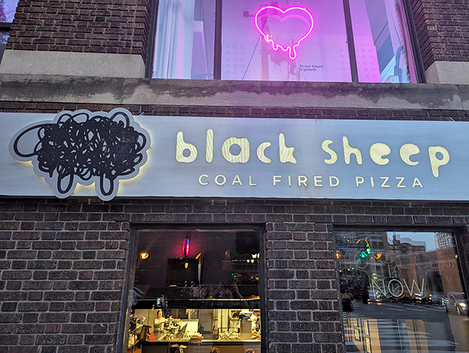 Black Sheep's neon heart glows like a beacon for pizza lovers &ndash; coal-fired perfection awaits inside those brick walls.