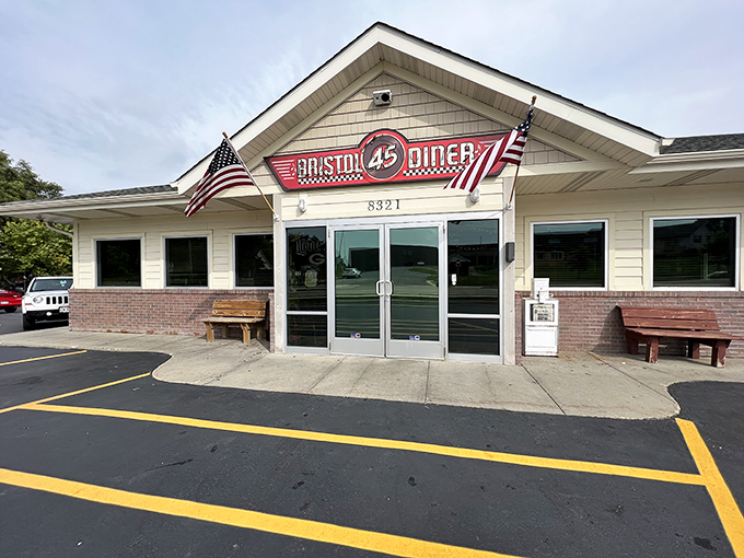 Clean lines, American flags, and that racing-inspired sign—this place serves patriotism with a side of pancakes!