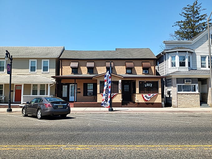 Lou's Barbershop stands as a time capsule on this quiet Egg Harbor City street, where haircuts come with free local gossip.