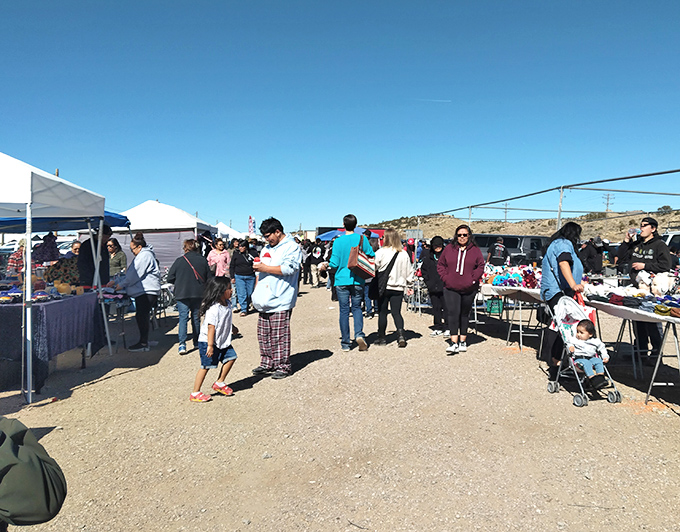 Gallup Flea Market buzzes with shoppers hunting treasures under canopies that dance in the desert breeze.
