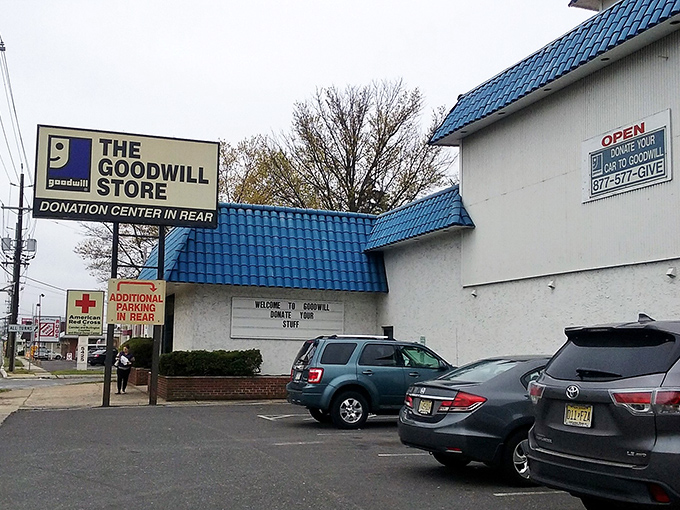 The distinctive blue-roofed Goodwill stands like a thrifting castle, complete with its own donation drop-off moat in the back.