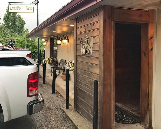 That rustic wooden entrance with flower boxes says "come on in" louder than any fancy sign ever could.