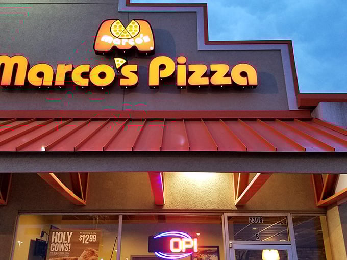 Marco's bright signage cuts through the evening sky like a beacon for pizza lovers. When that orange glow appears, your taste buds know what's coming.