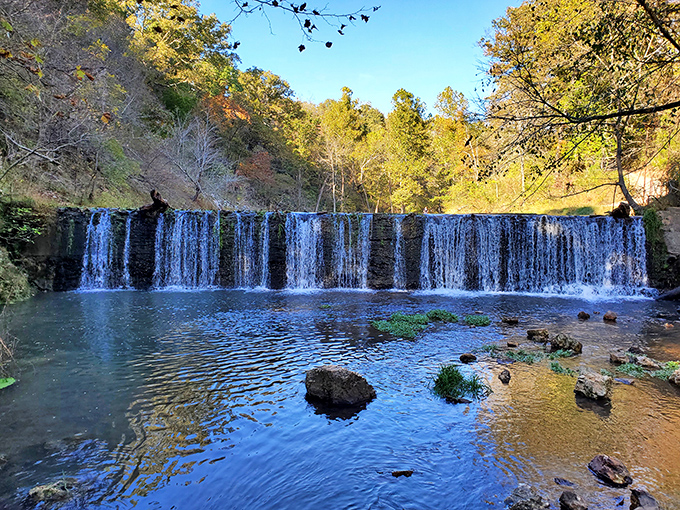 This waterfall cascades with the elegance of a Broadway curtain call, complete with autumn's standing ovation.