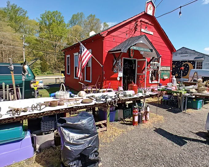 The charming red schoolhouse of New Egypt Flea Market Village stands out against the blue sky. School is in session—and today's lesson is Bargain Hunting 101!