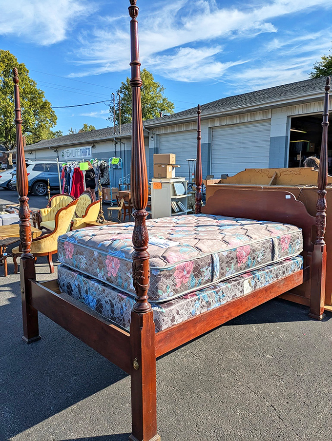 Four-poster beds and vintage furniture bask in the sunshine, proving New Life Thrift's treasures can't be contained indoors.