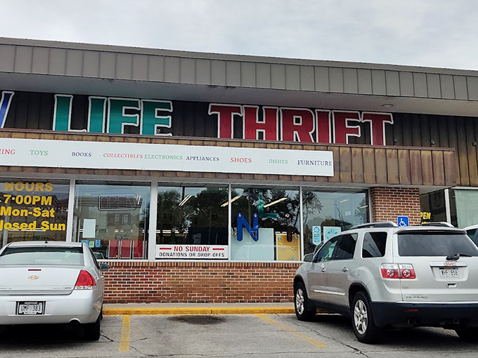 New Life Thrift's rainbow-colored sign promises a spectrum of secondhand treasures inside.