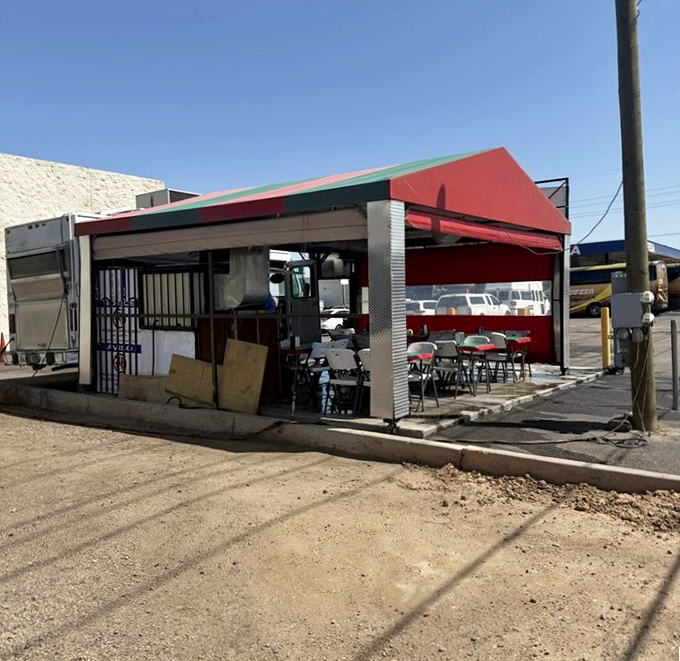 Nogales Hot Dogs' tent setup is where hot dog magic happens after dark. The best street food experiences often come with plastic chairs.
