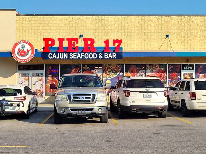 Pier 17's bold yellow building stands out like a beacon for seafood lovers seeking authentic Cajun flavors in Louisville.