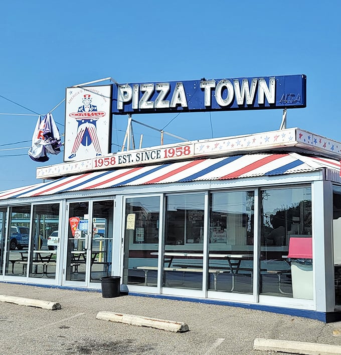 Pizza Town USA's retro signage shines like a beacon of Americana. This roadside classic has been serving slices since Eisenhower was president.