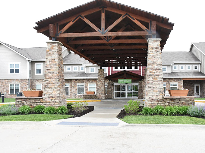 Prairie Vista's lodge-inspired entrance combines rustic wooden beams with stone columns &ndash; luxury that doesn't forget its Midwestern roots.