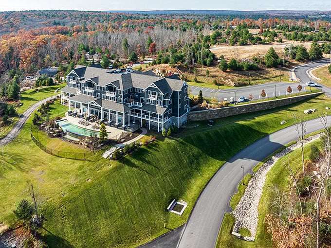 Richmond's blue-shingled castle emerges from the forest like a luxury cruise ship that somehow docked in the woods. That pool beckons like a sapphire oasis!