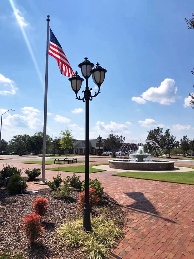 Public fountains and patriotic flags create that timeless American town square feeling we all secretly miss from simpler times.