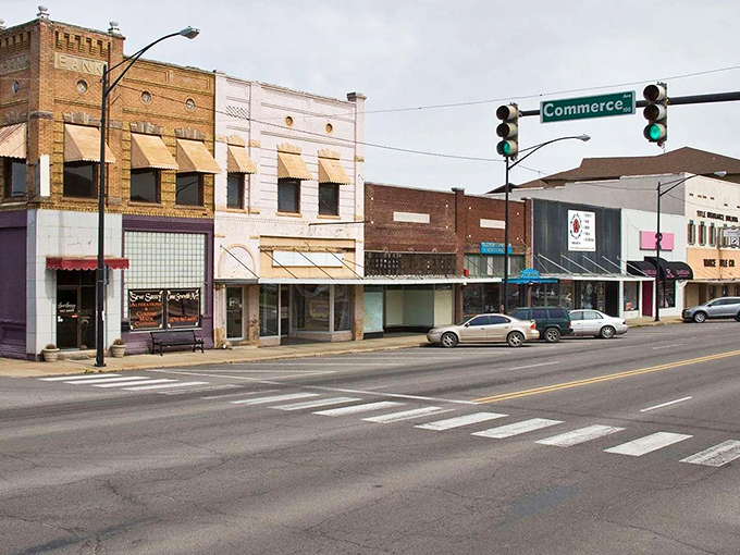 Russellville's street intersection pulses with college town energy, where traffic lights orchestrate small-city life perfectly.
