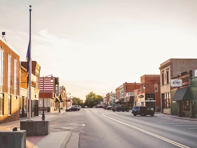 Golden hour glory! Sabetha's main street bathes in buttery sunset light, where even the "Cafe" sign seems to whisper, "Come in, the pie's still warm."