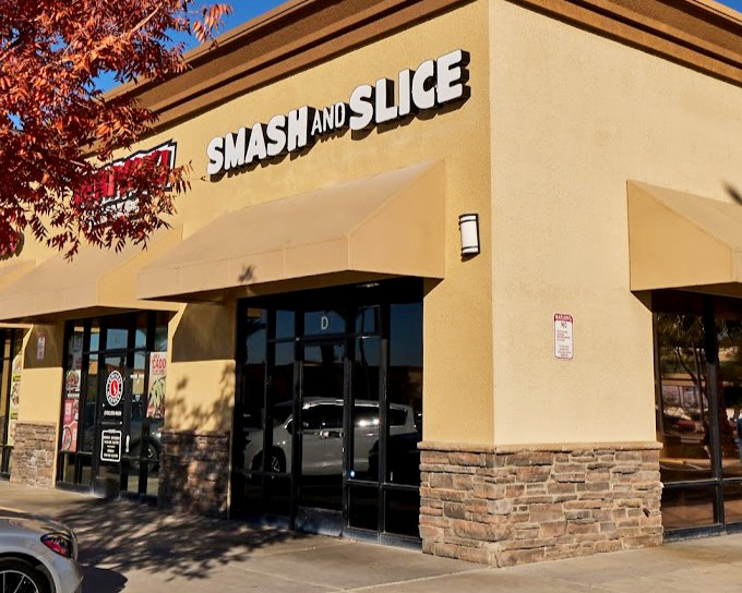 Smash and Slice's corner location catches afternoon shadows, a burger oasis in a strip mall desert. Salvation comes in smashed patty form!