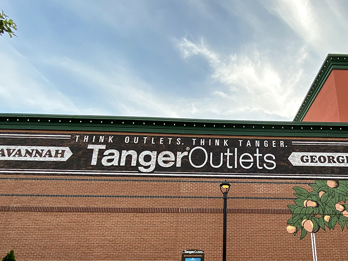 The "Think Outlets, Think Tanger" motto on brick walls speaks directly to every devoted bargain hunter's heart.