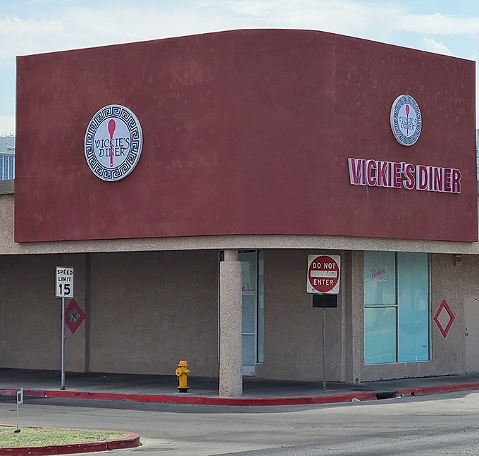 Vickie's Diner's burgundy facade stands like a delicious time capsule, preserving flavors from an era when diners were the original social networks.