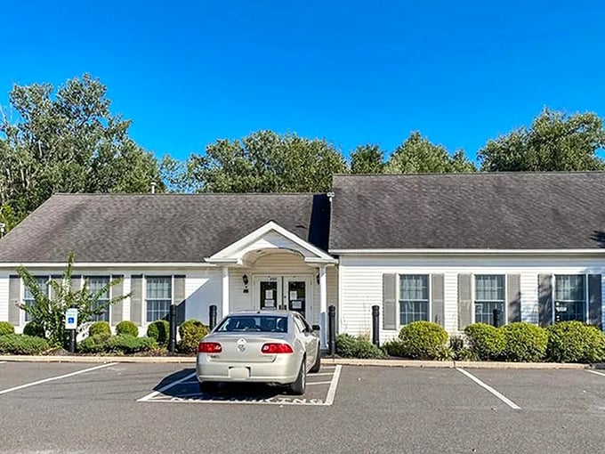 The community center gleams in crisp white under a perfect blue sky—where residents gather for everything from tax seminars to Tuesday night poker tournaments.