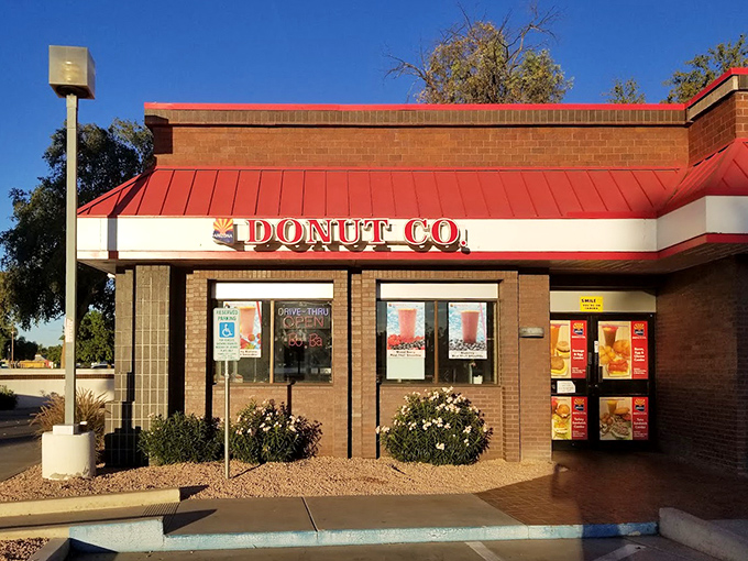 The desert sun highlights Arizona Donut Co.'s classic brick exterior. Inside awaits a cool oasis of glazed perfection.