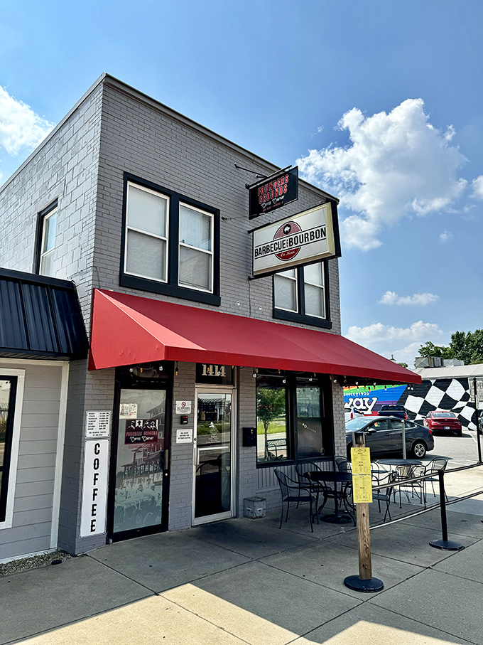 The gray brick building with bold signage stands like a delicious landmark &ndash; BBQ and bourbon, what more could you want?